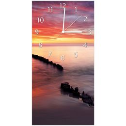 Wallario Wanduhr Sandstrand im Sonnenuntergang - Roter Himmel (Uhr aus Acryl), mit weißen Zeigern