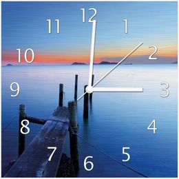 Wallario Wanduhr Steg im Wasser - Abendstimmung am Meer (Aluverbunduhr), blau, mit weißen Zeigern