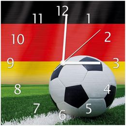 Wallario Wanduhr Fußball vor einer Deutschlandflagge (Aluverbunduhr), rot, mit weißen Zeigern