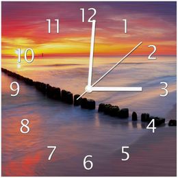 Wallario Wanduhr Farbenspiel im Himmel - Sonnenuntergang am Strand (Aluverbunduhr), rot, mit weißen Zeigern