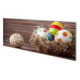 Wallario Wandgarderobe Bunte bemalte Eier an Ostern im Vorgelnest vor hölzerner Wand (1-teilig