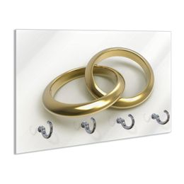 Wallario Schlüsselbrett Zwei goldene Eheringe in Nahaufnahme auf weißem Grund
