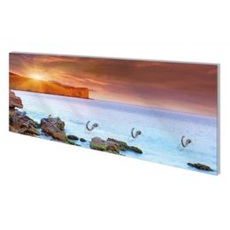 Wallario Wandgarderobe Sonnenaufgang am Meer mit Landzunge und Felsen im Wasser (1-teilig