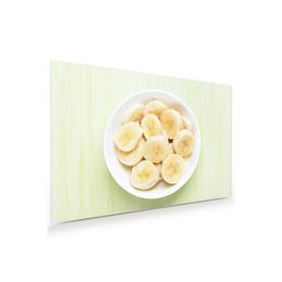 Primedeco Glasbild Wandbild Bananen auf Teller mit Aufhängung