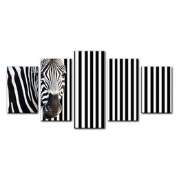 Bilderdepot24 Leinwandbild Zebra vor einem gestreiften Hintergrund