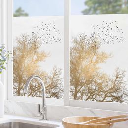 Fensterfolie Vogelschwarm vor goldenem Baum