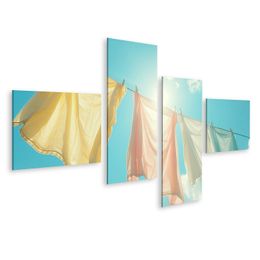 islandburner Leinwandbild Leuchtende Pastelltücher trocknen an einer Leine vor blauem, sonnigen