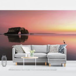 Bilderwelten Fototapete Strand modern Wandtapete rot - Nat&uuml;rliche Br&uuml;cke im Sonnenuntergang - K&uuml;ste Wohnzimmer Schlafzimmer