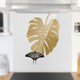 Bilderwelten Glas Spritzschutz Tropisch gold Tiere - Goldene Monstera mit Schmetterling - Pflanzen K&uuml;chenr&uuml;ckwand aus Glas