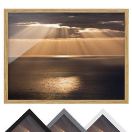 Bild mit Rahmen Sonnenstrahlen &uuml;ber dem Meer