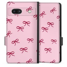 DeinDesign Google Pixel 7a Handy Klapphülle Handyhülle aus Kunst Leder schwarz Flip Case Pattern Schleifen Bow Sideflip mit Lasche