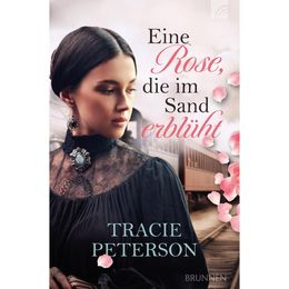 Eine Rose, die im Sand erbl&uuml;ht
