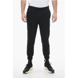 Neil Barrett Skinny Fit Sweatpants aus Baumwolle mit B&uuml;ndchen in Schwarz