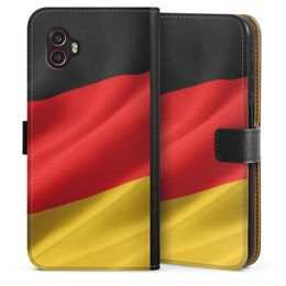 DeinDesign Galaxy XCover 6 Pro Handy Klapph&uuml;lle Handyh&uuml;lle aus Kunst Leder schwarz Flip Case Flags Flag Germany Sideflip mit langer Lasche
