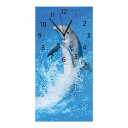 Wallario Uhr 30 x 30 cm, wei&szlig;e Zeiger Fr&ouml;hlicher Delfin im blauen Wasser