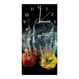 Wallario Uhr 30 x 60 cm, wei&szlig;e Zeiger Paprika-Mix - frische Paprika in rot, gelb und gr&uuml;n im Wasser