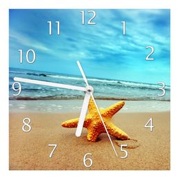 Wallario Uhr 30 x 30 cm, schwarze Zeiger Seestern am Strand am Meer