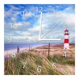 Wallario Uhr 30 x 60 cm, schwarze Zeiger Leuchtturm am Strand von Sylt