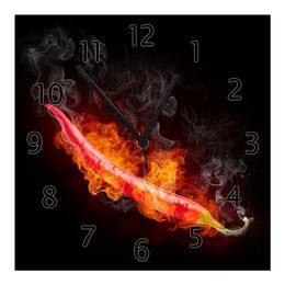 Wallario Uhr 30 x 30 cm, wei&szlig;e Zeiger Hei&szlig;e, brennende Chili-Schote vor schwarzem Hintergrund
