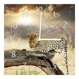 Wallario Uhr 30 x 60 cm, schwarze Zeiger Leopard auf Baumstamm in Afrika